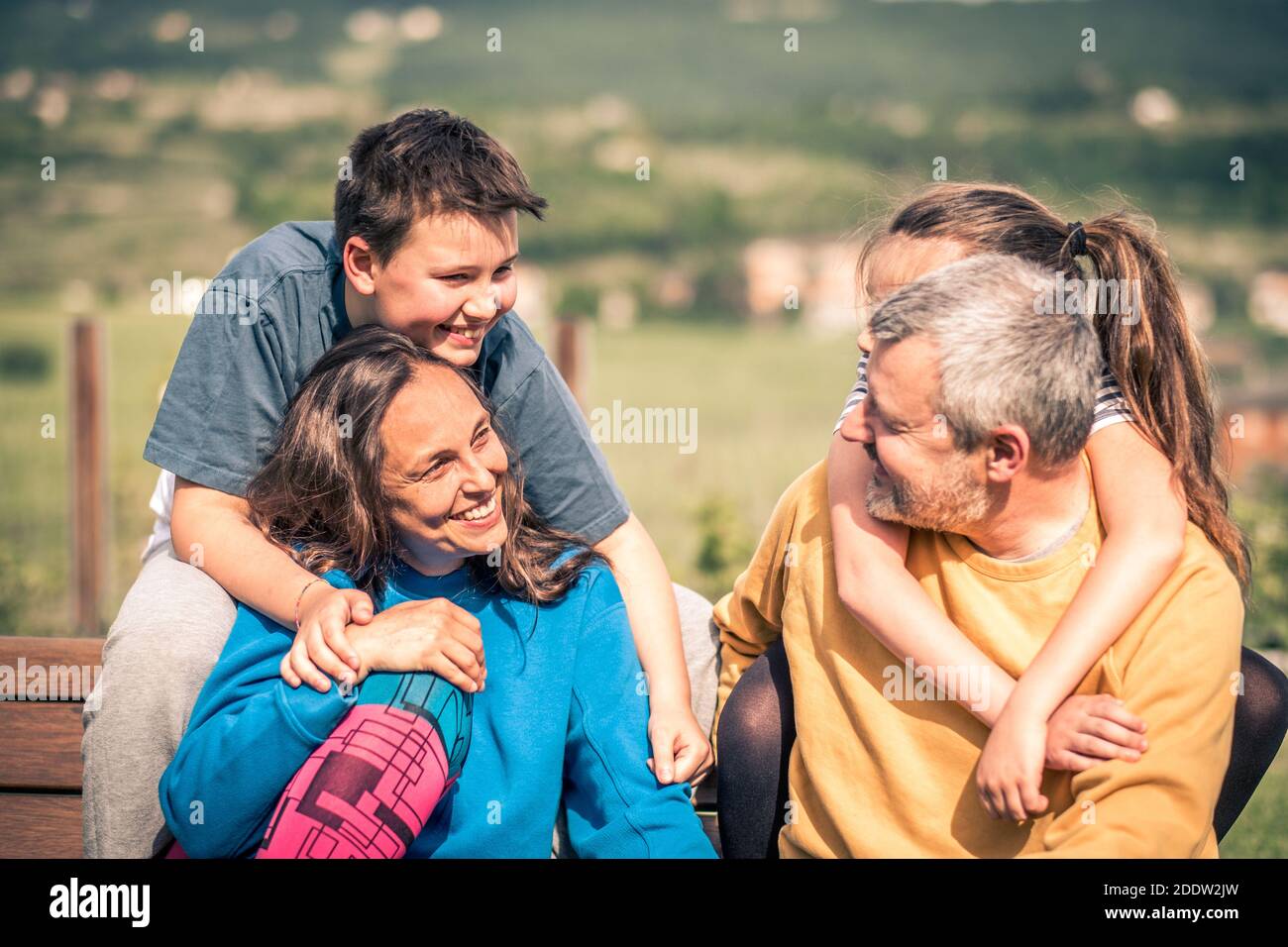 Beautiful family sitting on bench hi-res stock photography and images ...