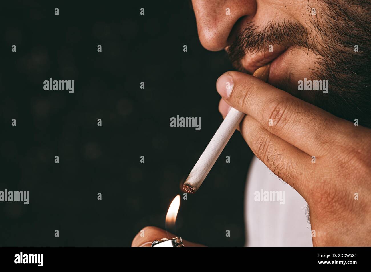 Bearded man lighting cigarette with fire lighter Stock Photo - Alamy