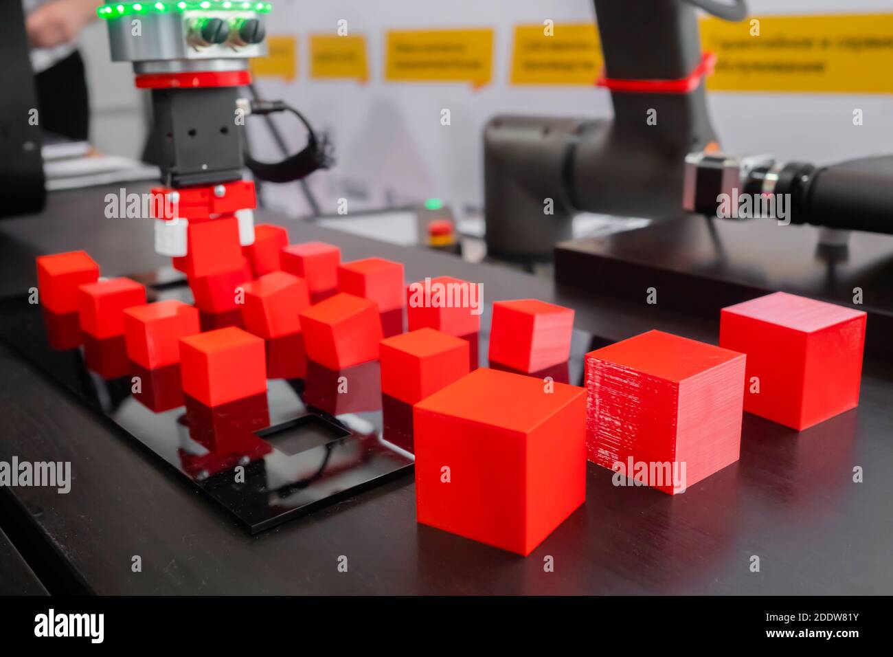 Pick and place robotic arm manipulator moving red toy blocks at robot exhibition Stock Photo - Alamy