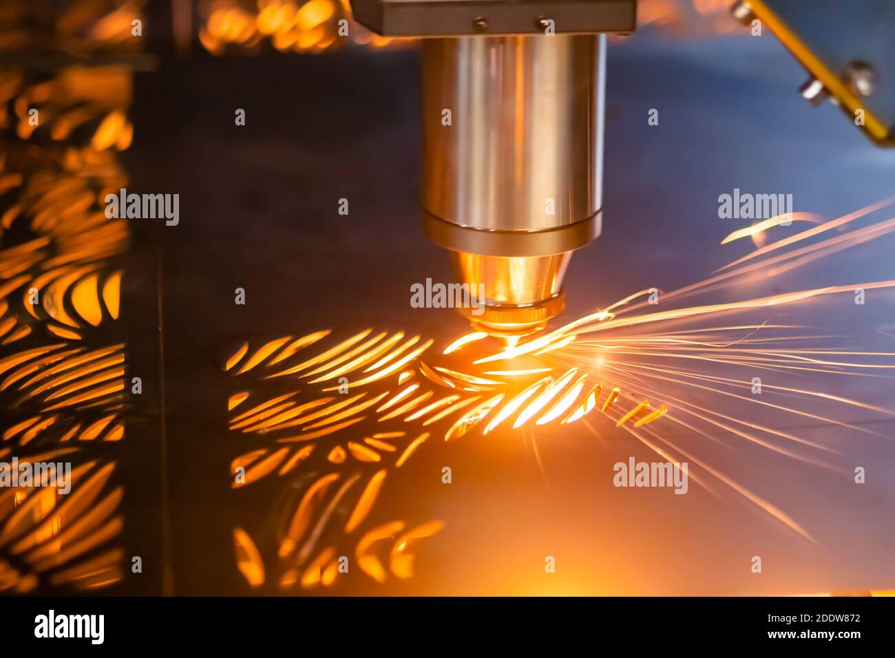 Laser cutting machine working with sheet metal with sparks in dark ...