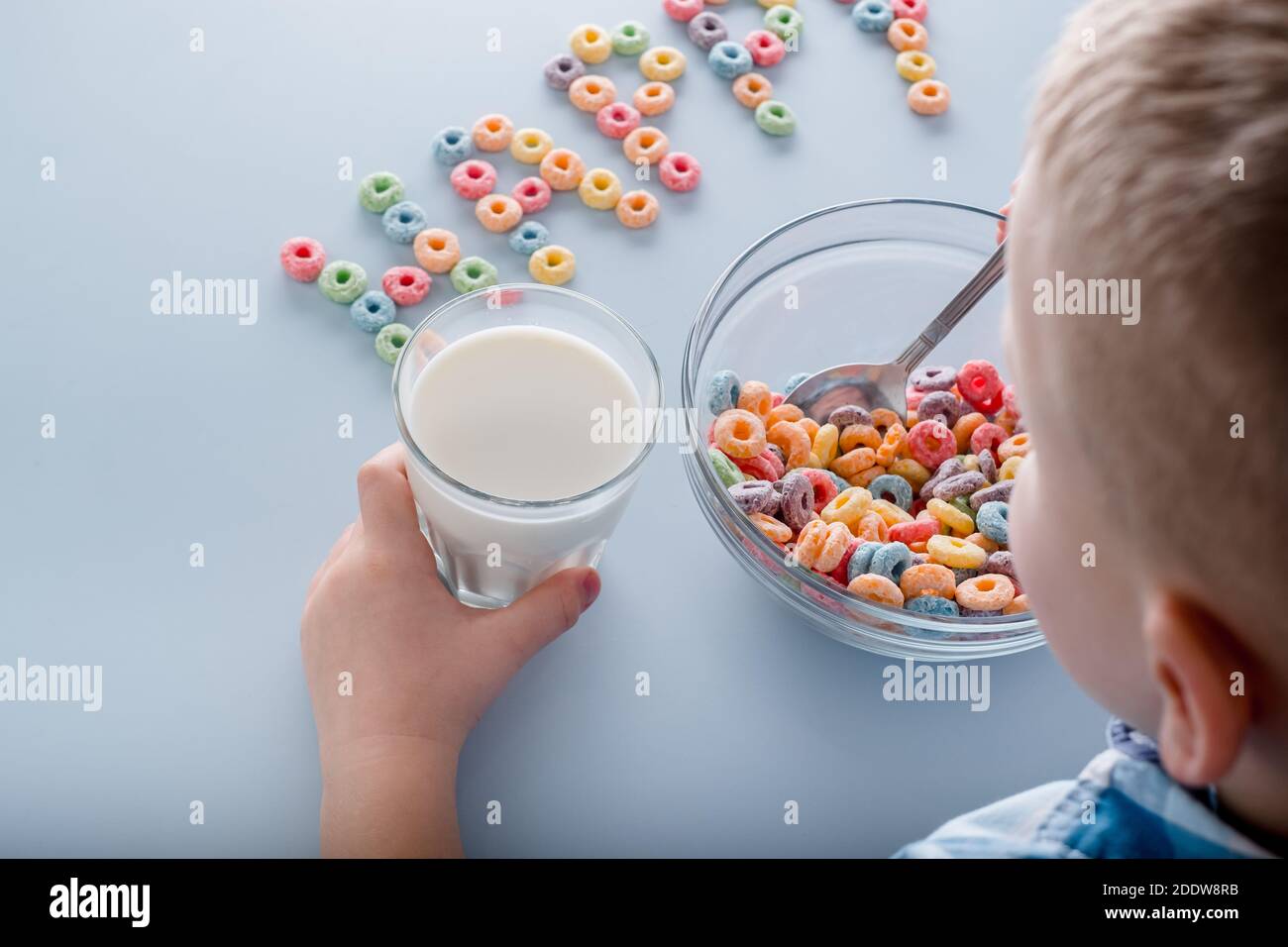 The child eating a breakfast cereal. word with grain loops happy on a ...