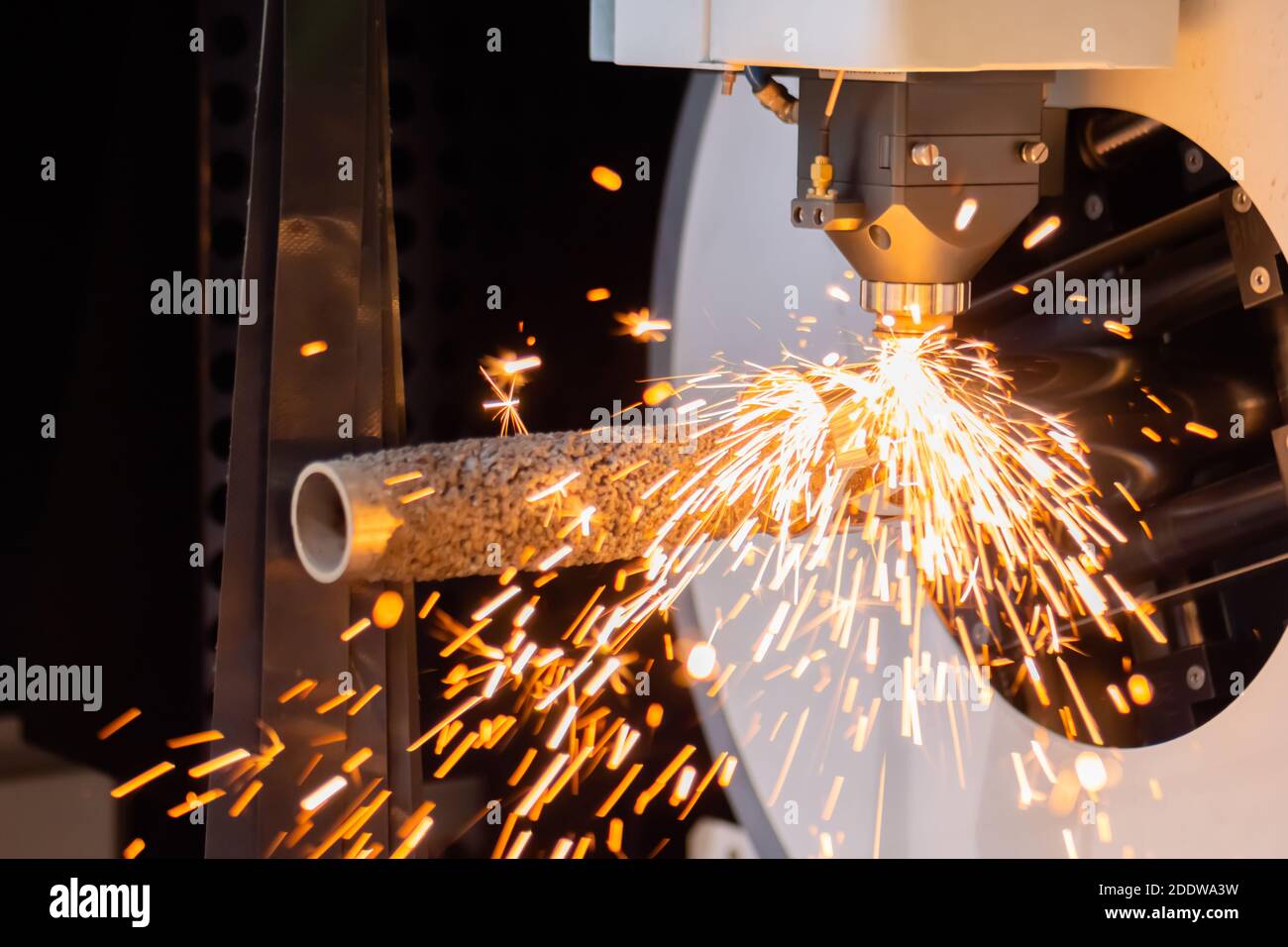 Laser cutting machine working with cylindrical metal workpiece with ...