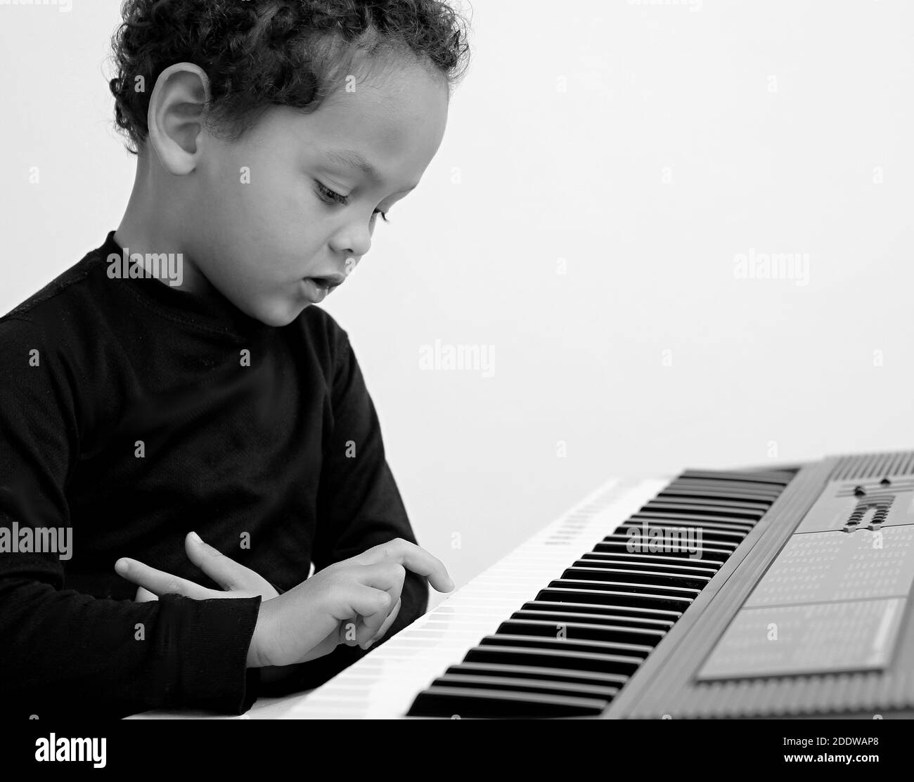 Child play piano Black and White Stock Photos & Images - Alamy
