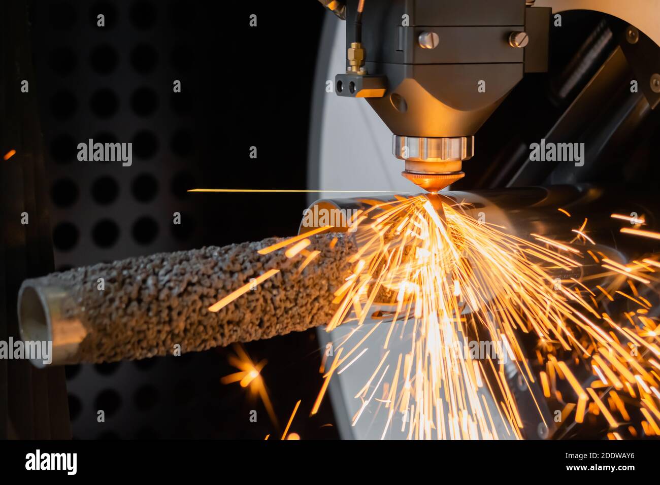 Cnc laser cutting machine working with cylindrical metal workpiece with ...