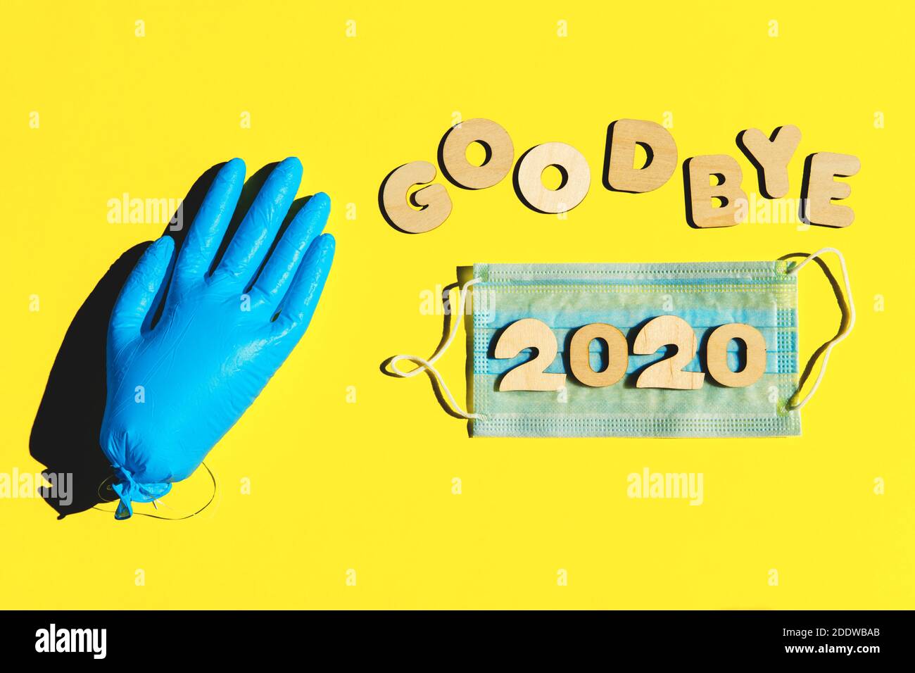 Words GOODBYE 2020 from wooden letters, inflated medical glove waving ...