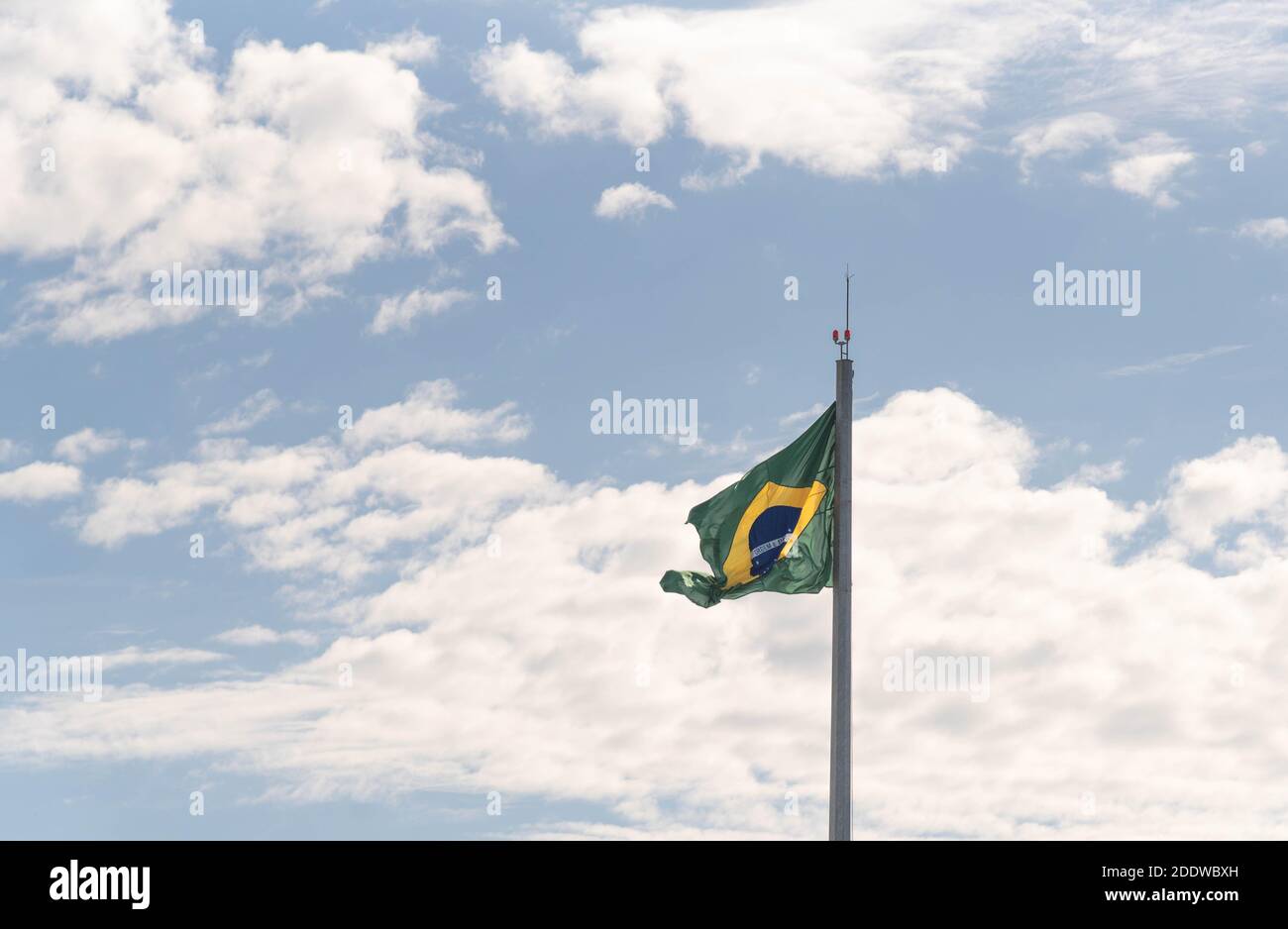 Brazil's flag. Blue sky and clouds. Symbol of the republic ...