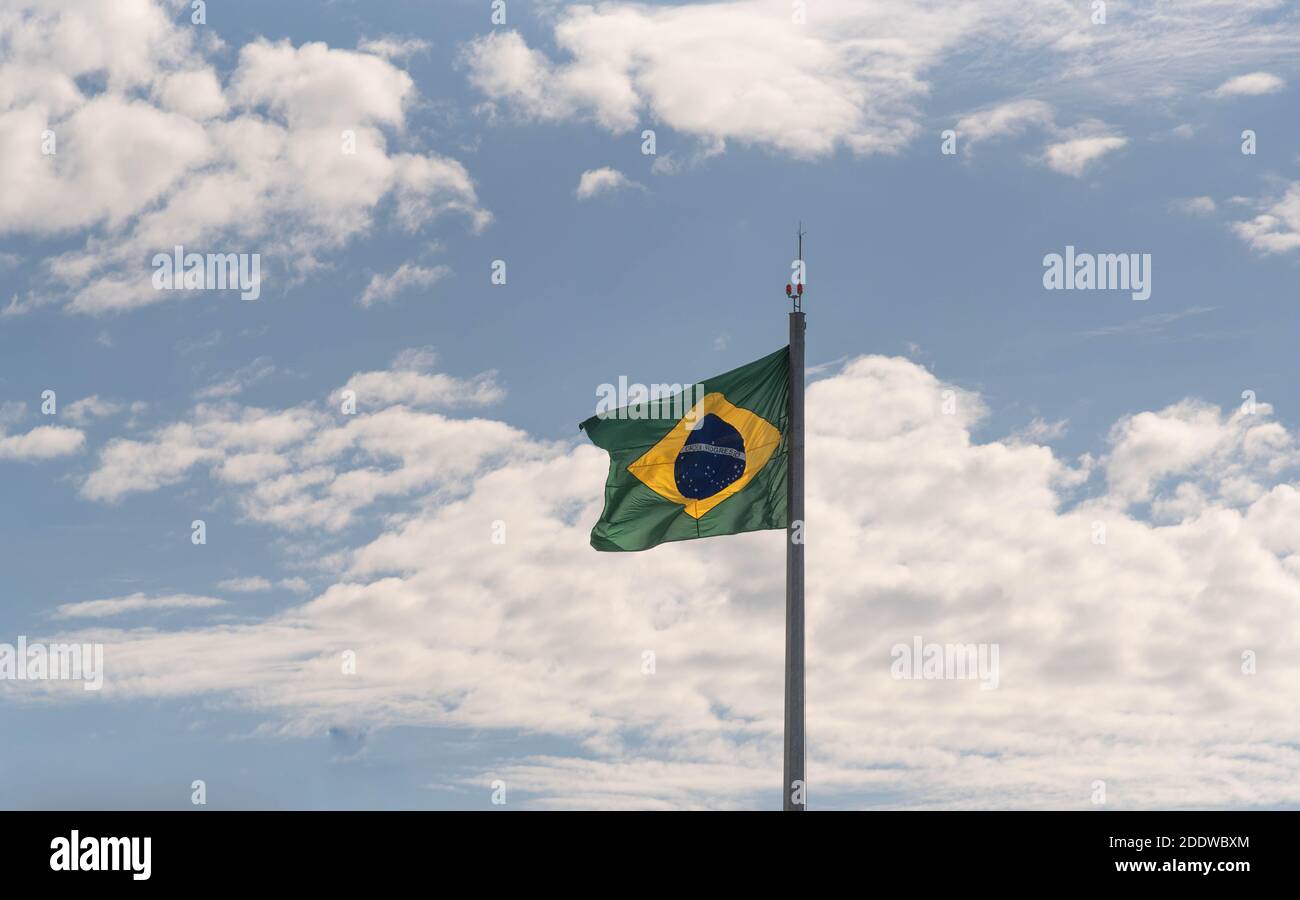 Brazil's flag. Blue sky and clouds. Symbol of the republic ...