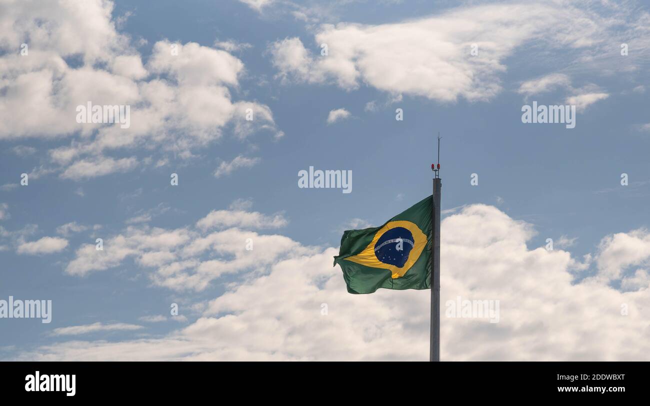 Brazil's flag. Blue sky and clouds. Symbol of the republic ...