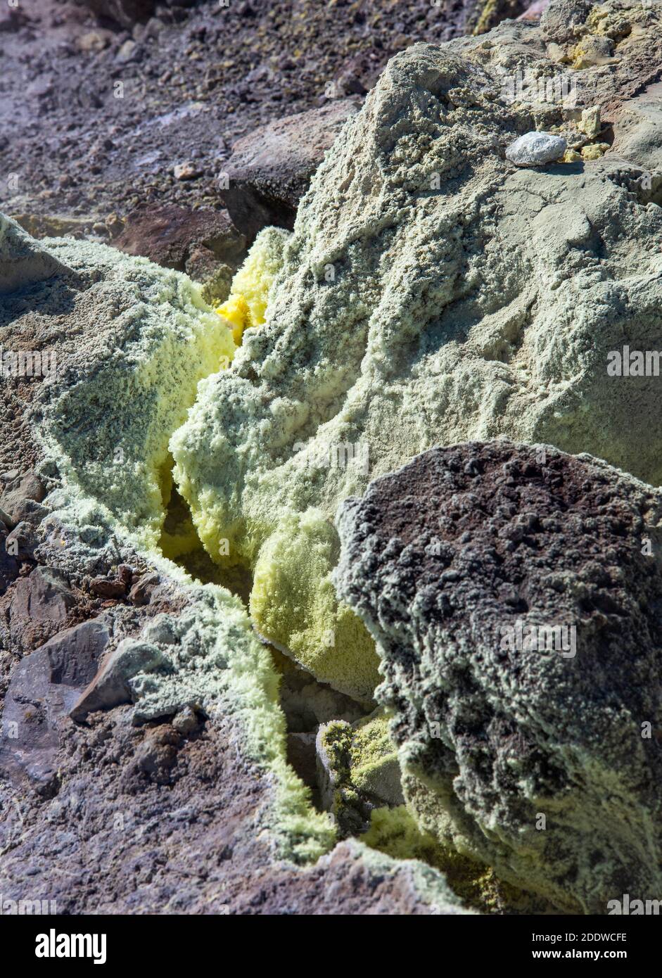 Sulfur haze and its crystals on the lava rocks. Volcano Island in the ...
