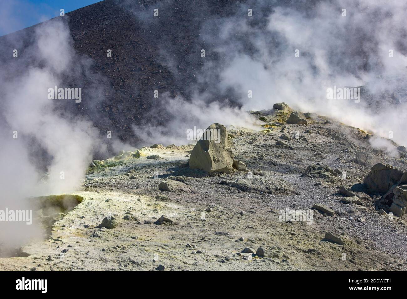Sulfur haze and its crystals on the lava rocks. Volcano Island in the ...