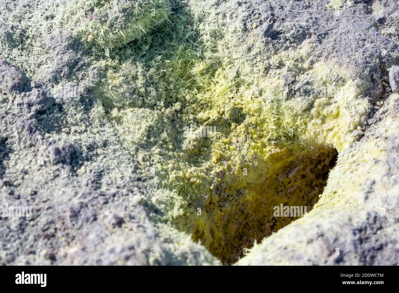 Sulfur haze and its crystals on the lava rocks. Volcano Island in the ...