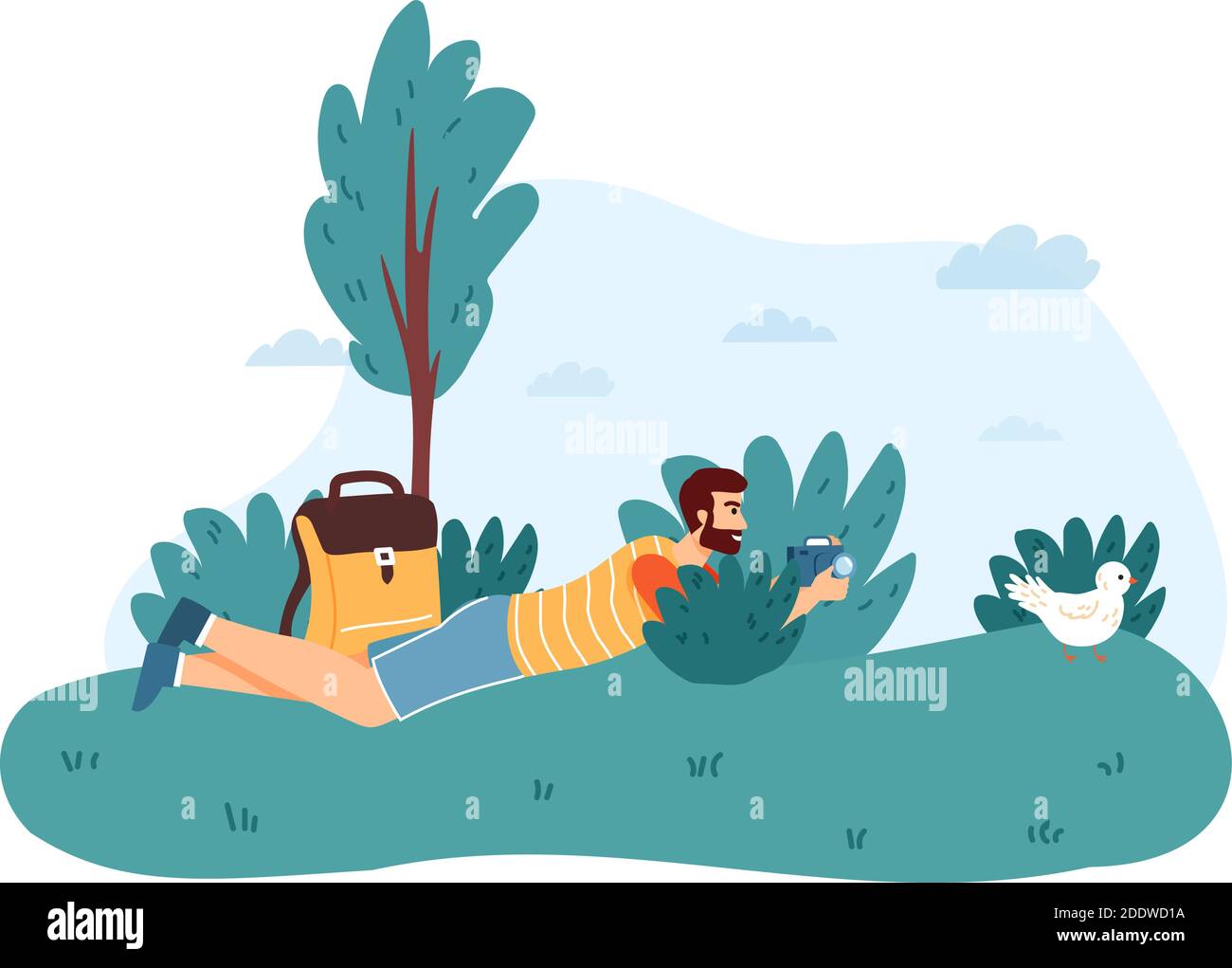 Man photographer lying in bushes and taking photo of bird. Male ...