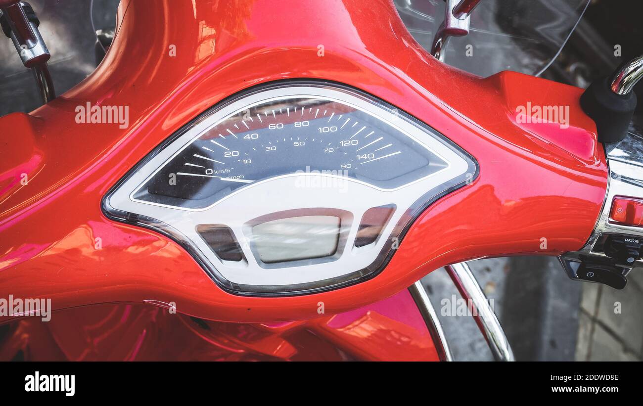 Speedometer on the handlebar of a glossy red motorcycle. Closeup photo ...