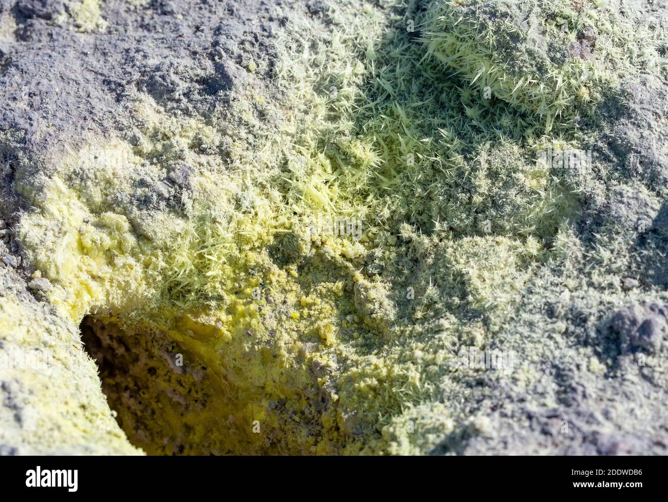 Sulfur haze and its crystals on the lava rocks. Volcano Island in the ...
