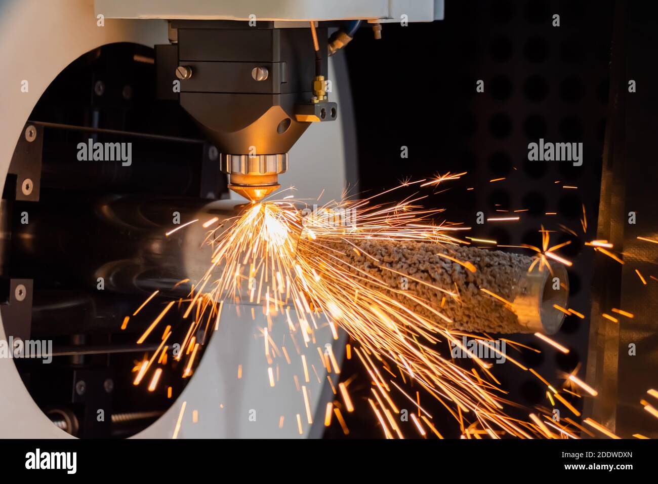 Laser cutting machine working with cylindrical metal workpiece with ...