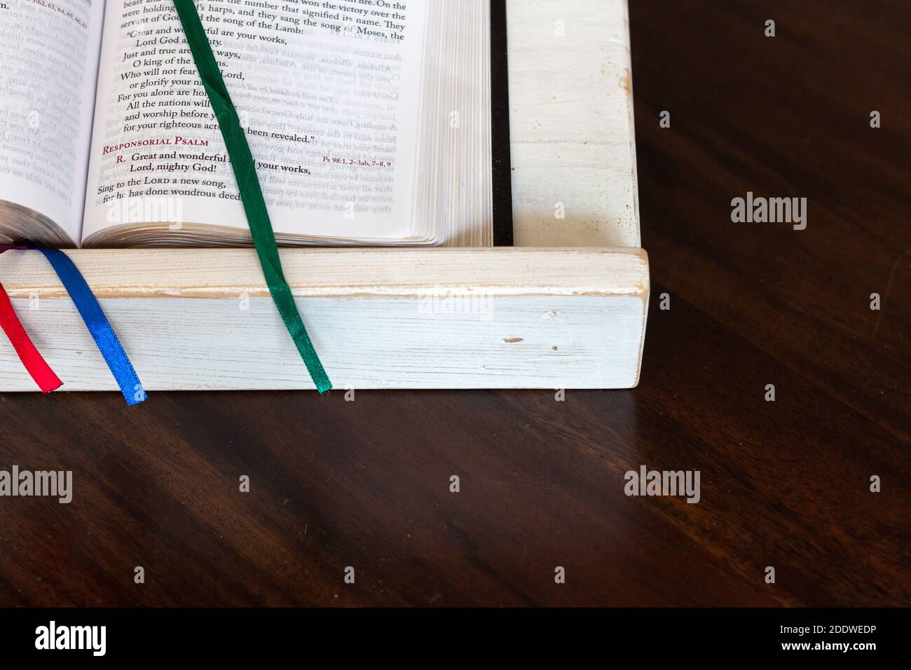 Open bible with daily readings Christian on white bible stand and dark ...