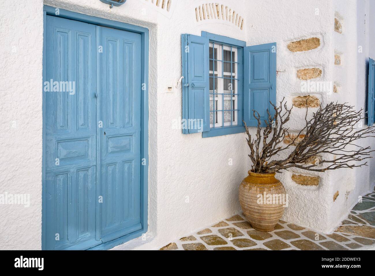 Typical Cycladic architecture, a whitewashed house with blue windows ...