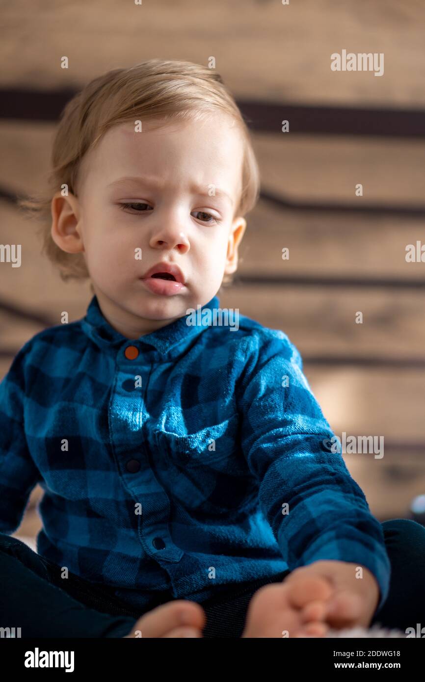 childhood, infant, minor concepts - close up one blonde black-eyed sad ...