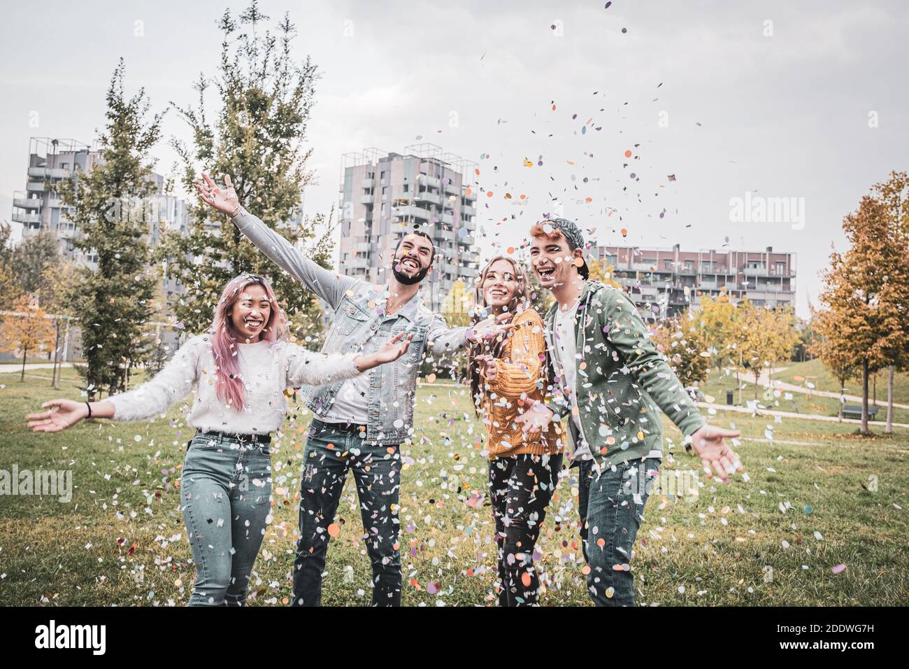 Group of stylish friends smiling and enjoying party throwing colorful ...