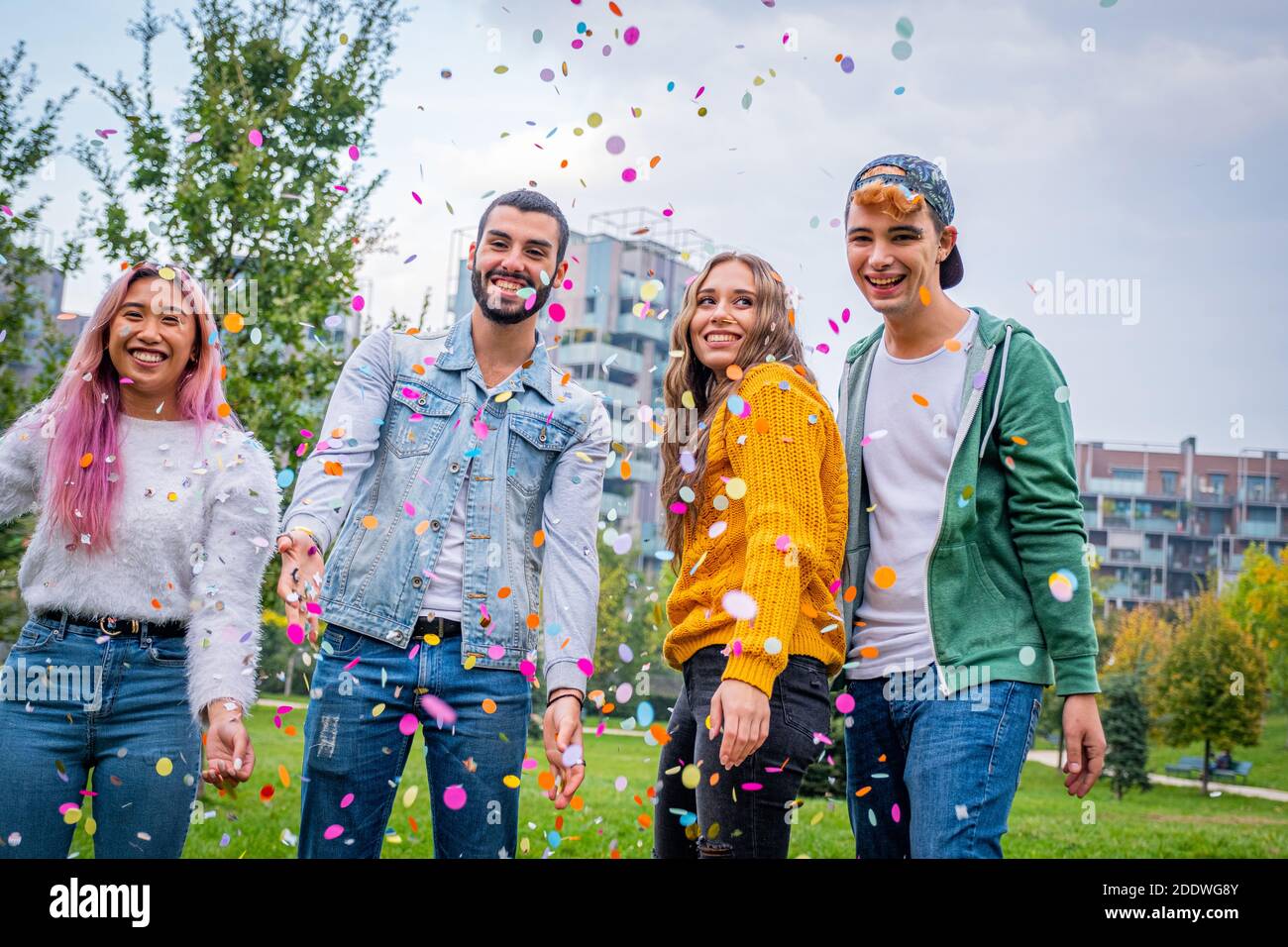 Group of stylish friends smiling and enjoying party throwing colorful ...