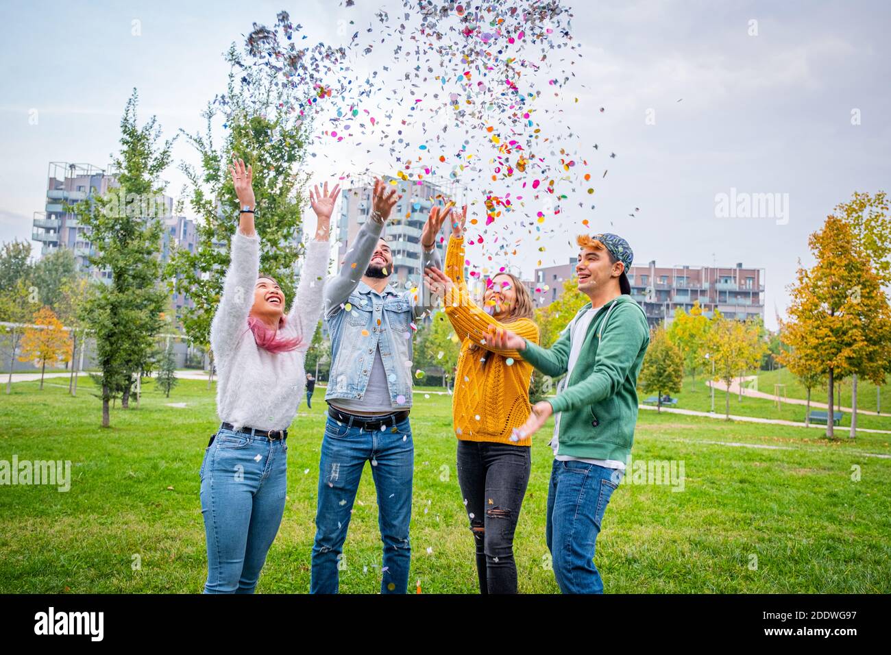 Group of stylish friends smiling and enjoying party throwing colorful ...