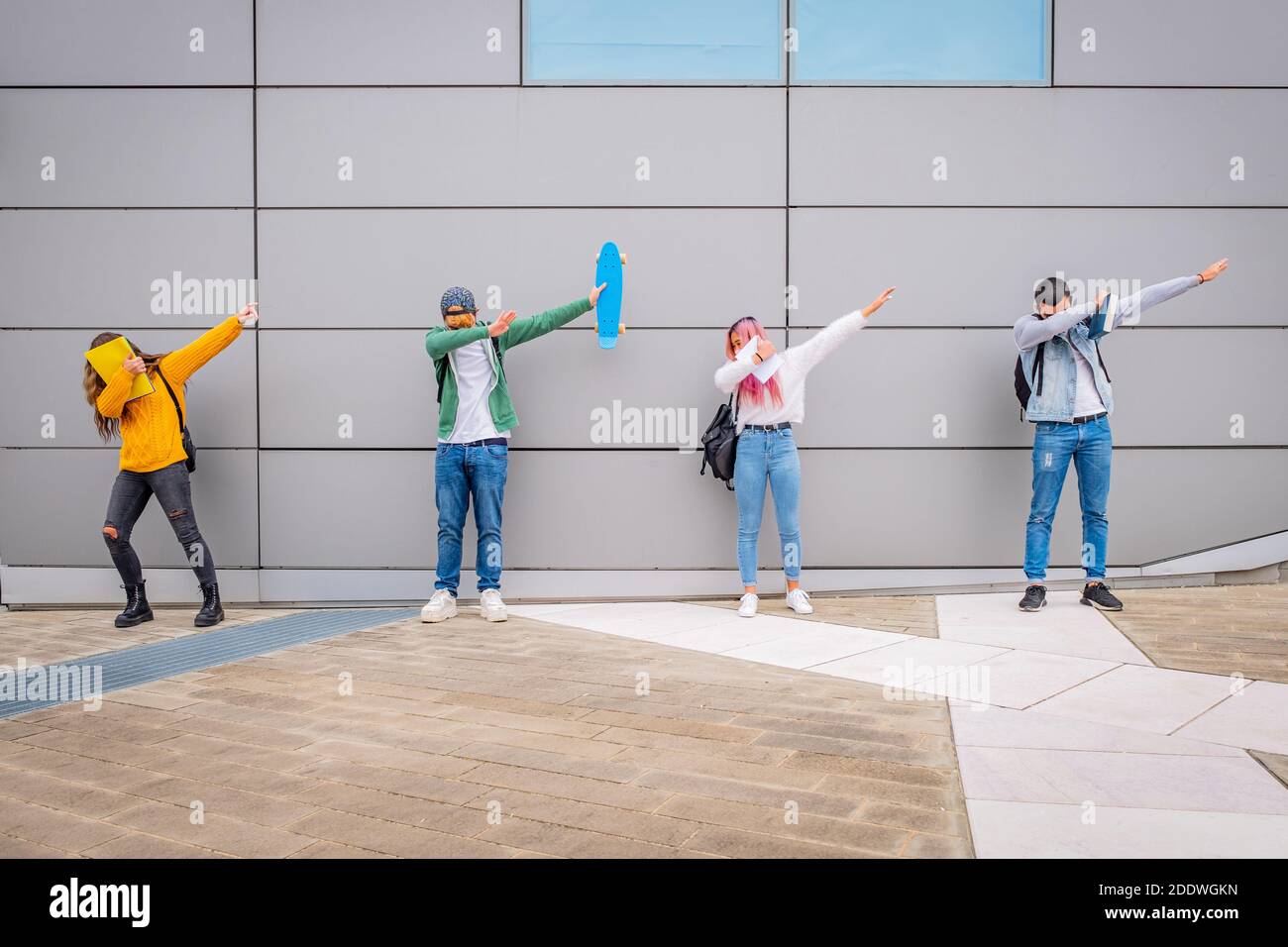 Multiethnic young people dancing the dab dance outdoor keeping social ...