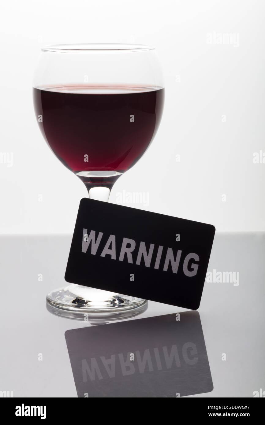 Warning sign in front of wine glass Stock Photo - Alamy