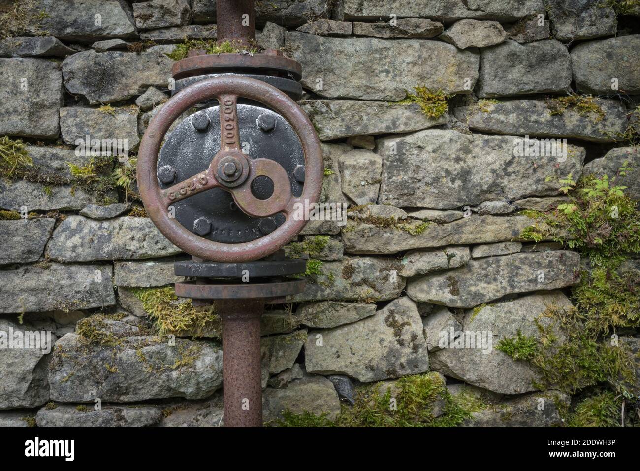 vintage pipework on a weathered stone wall Stock Photo - Alamy