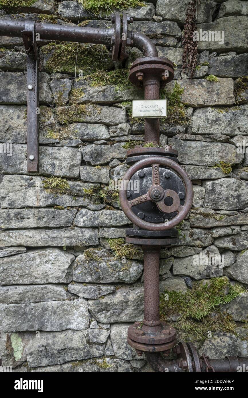 vintage pipework on a weathered stone wall Stock Photo - Alamy