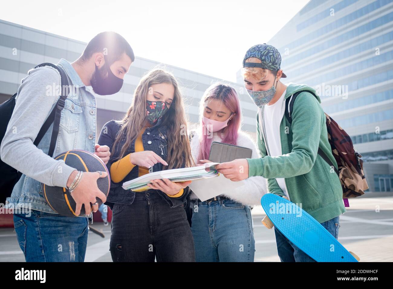 Multiracial students with face mask studying at college campus - New ...