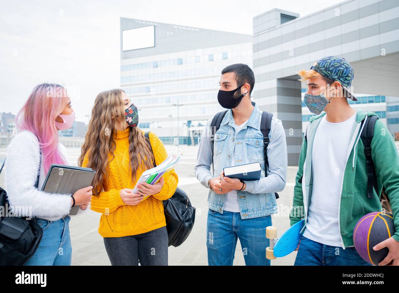 Multiracial students with face mask studying at college campus - New ...
