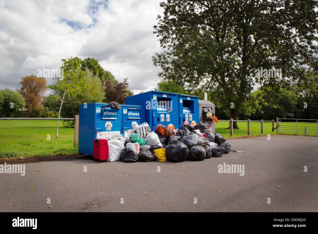stacked up rubbish by recycle bin that need collecting Stock Photo - Alamy