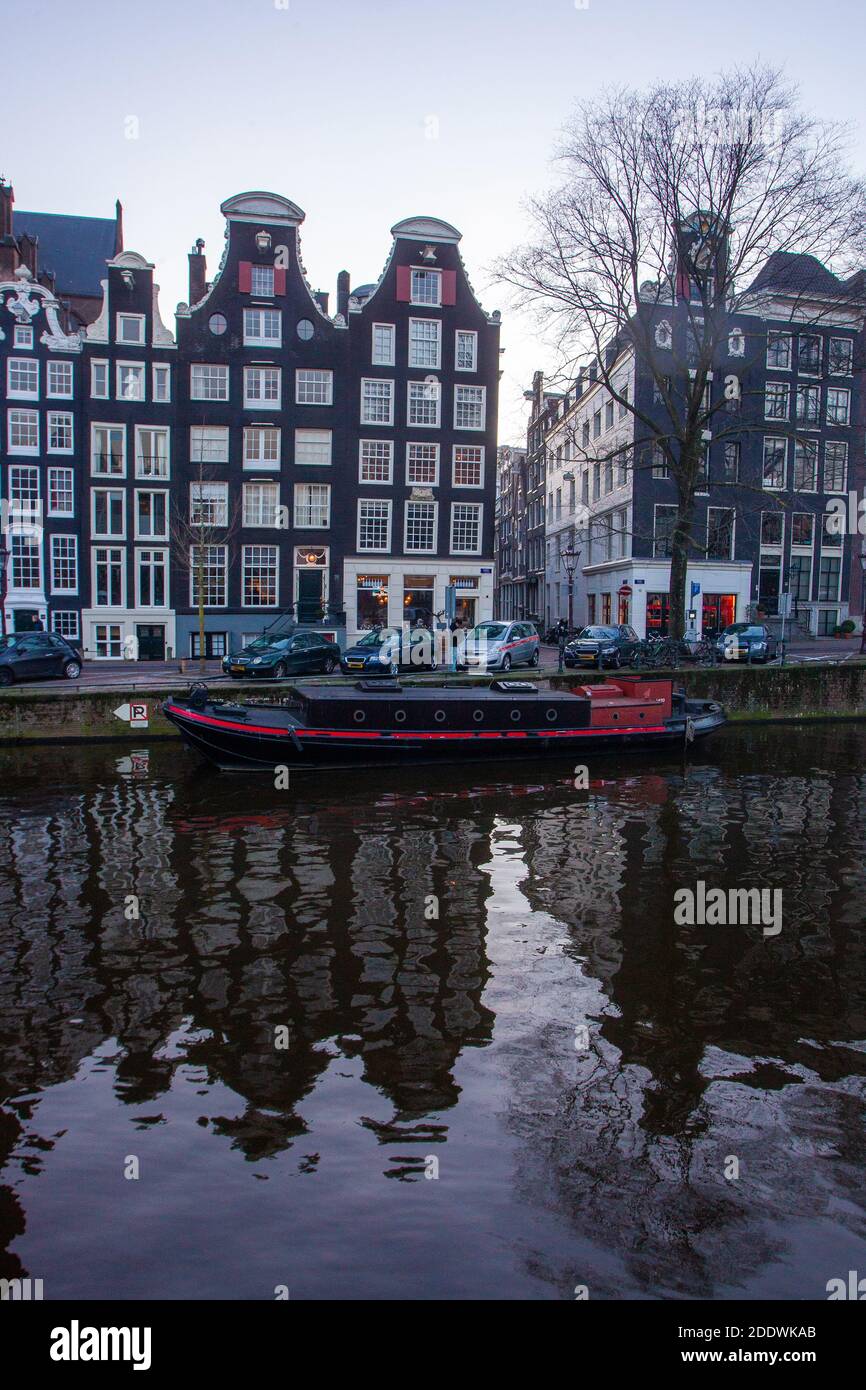 Canal , boat amd medieval architecture in Amsterdam. Reflection in ...