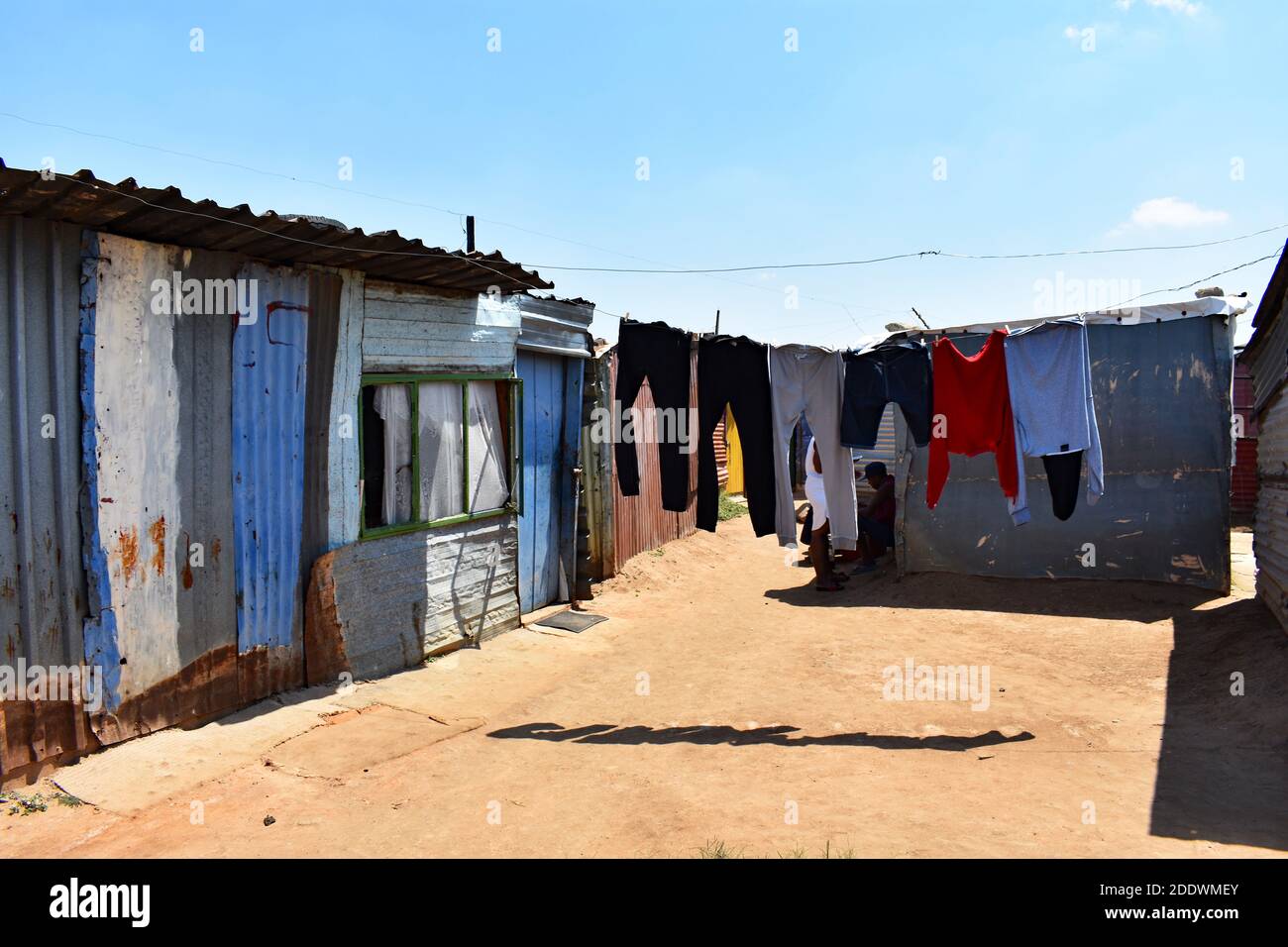 Clothing and bedding drying on the washing line and homes made of ...