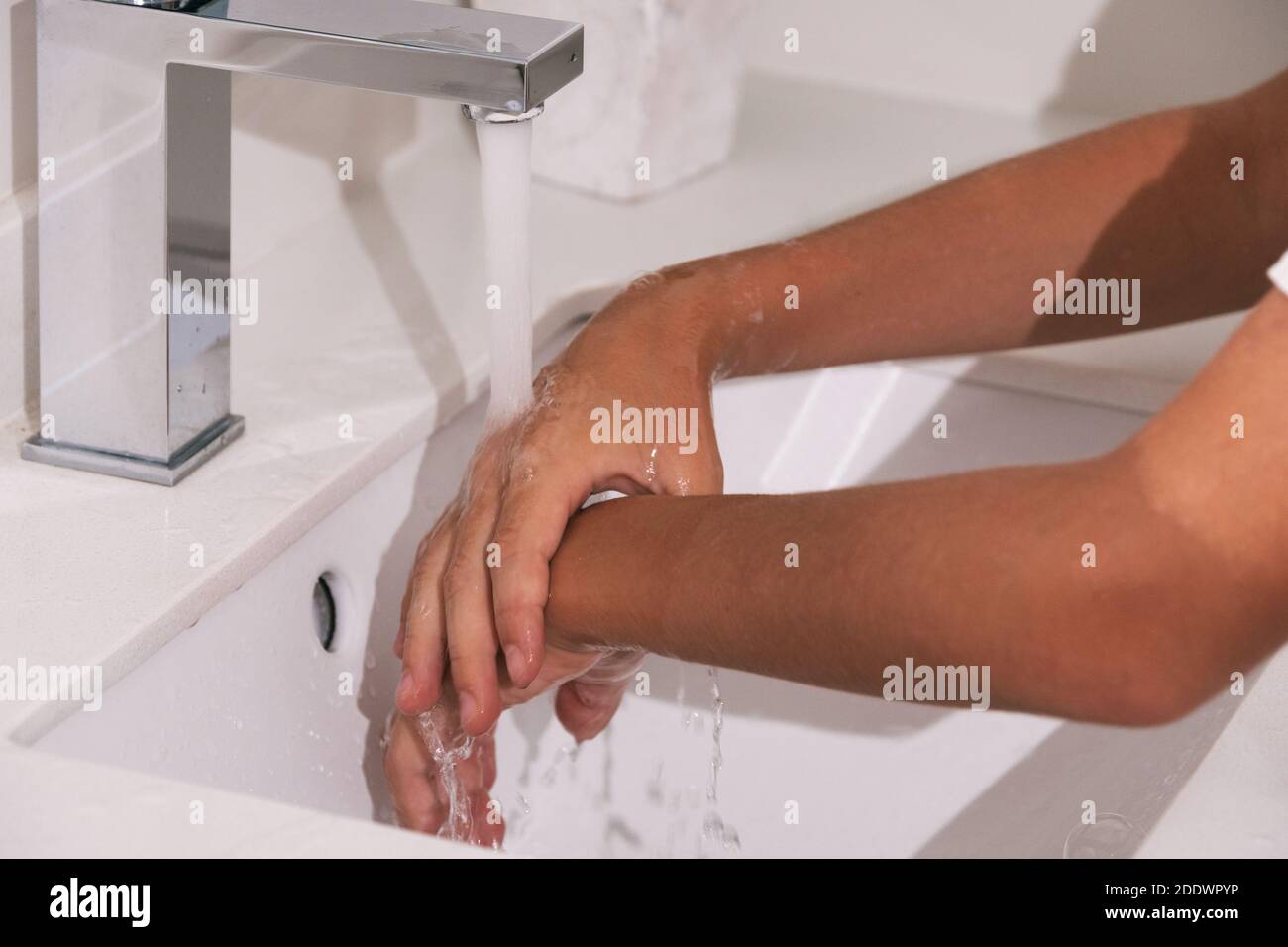 Stock photo of unrecognized person using soap and water to clean their ...