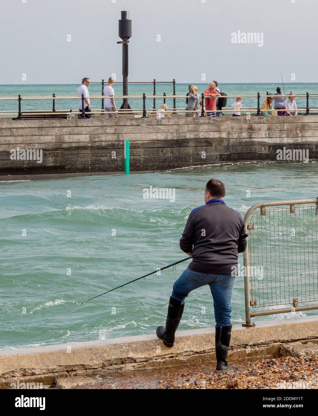 Man fishing on the River Arun, Littlehampton, West Sussex, UK Stock ...
