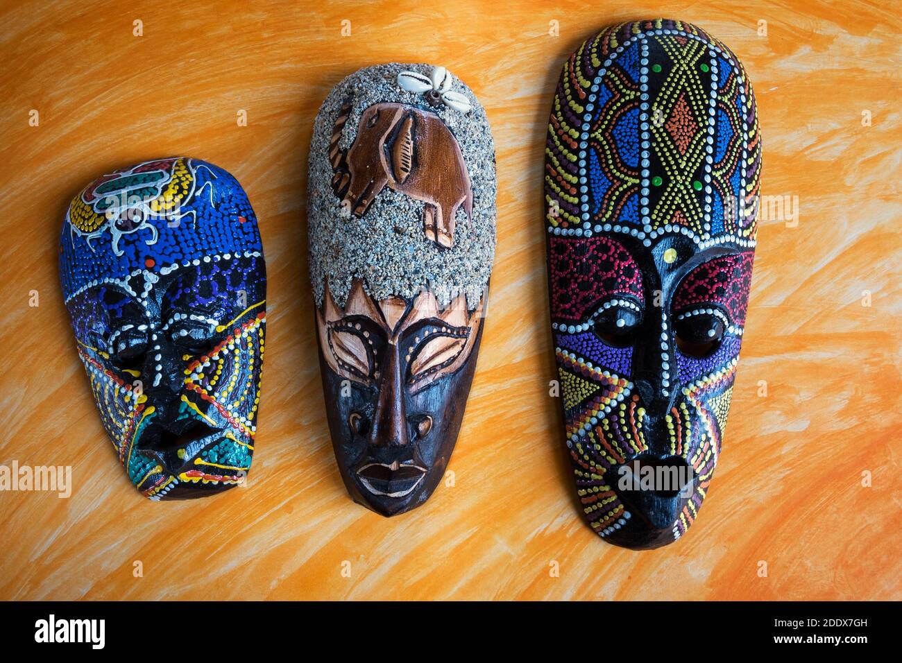 handmade african masks carved from the wood of African on orange ...