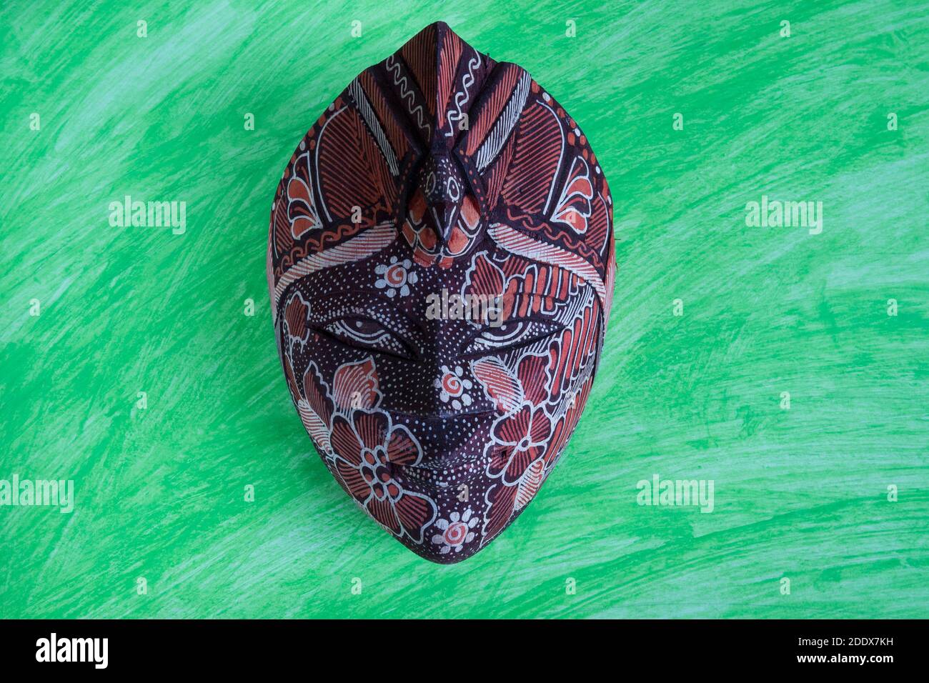 wooden colored african ethnic tribal mask on dark background for wall ...
