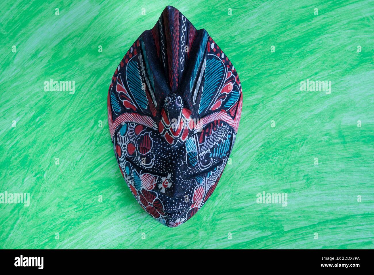 wooden colored african ethnic tribal mask on dark background for wall ...