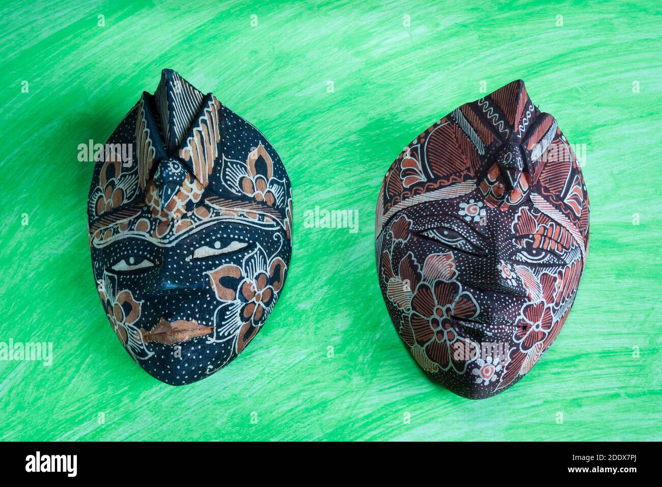 angry view of Colored handmade African masks carved from the wood of ...