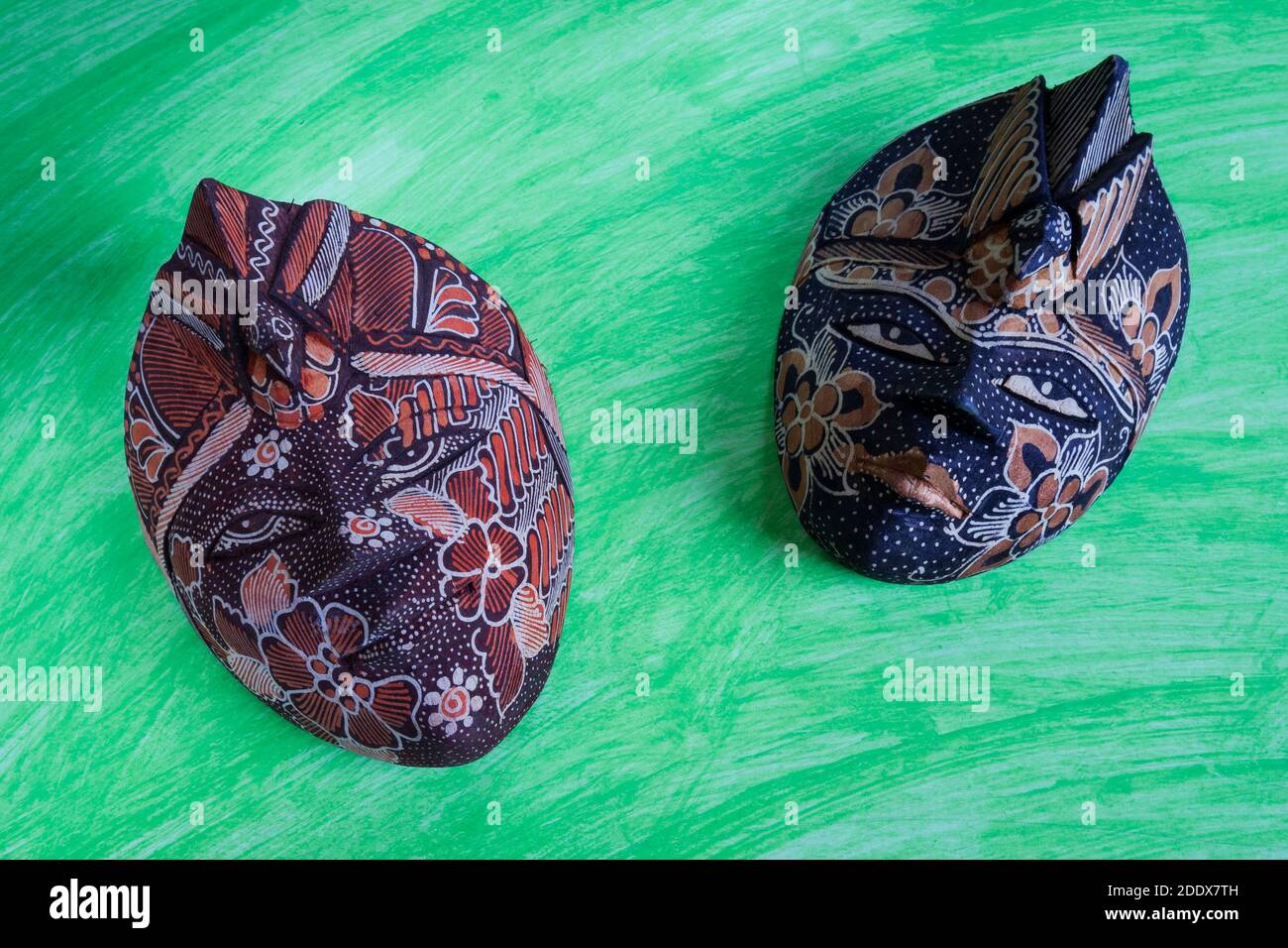 wooden colored african ethnic tribal masks on green background for wall ...