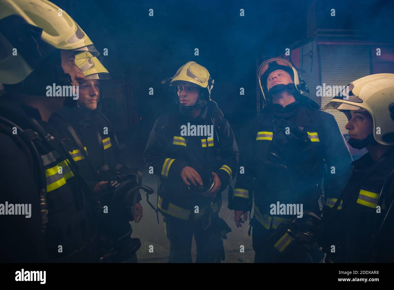 Group of firemen in the fire department organizing action plan for safe ...