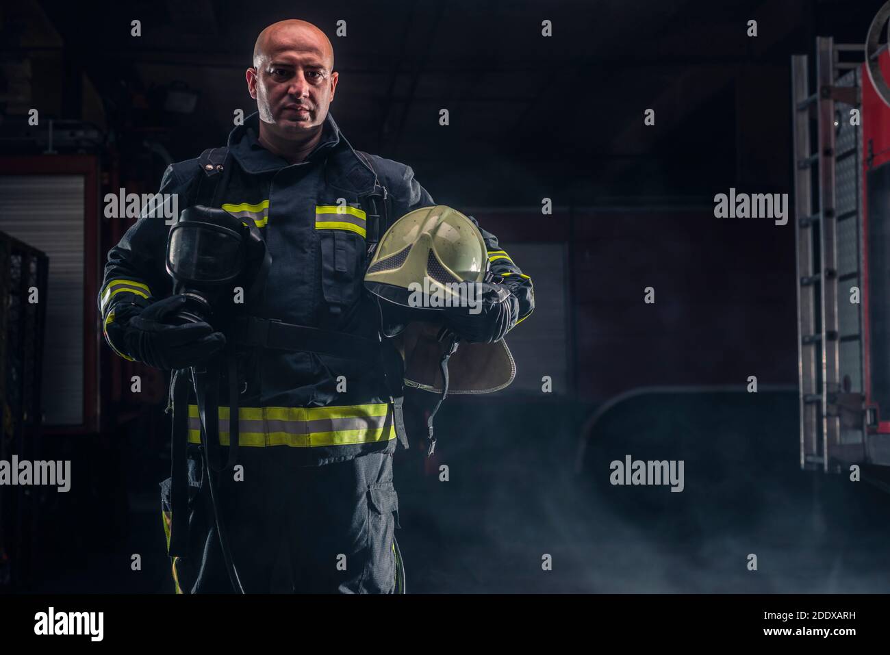 Fireman standing confident holding helmet and wearing firefighter ...