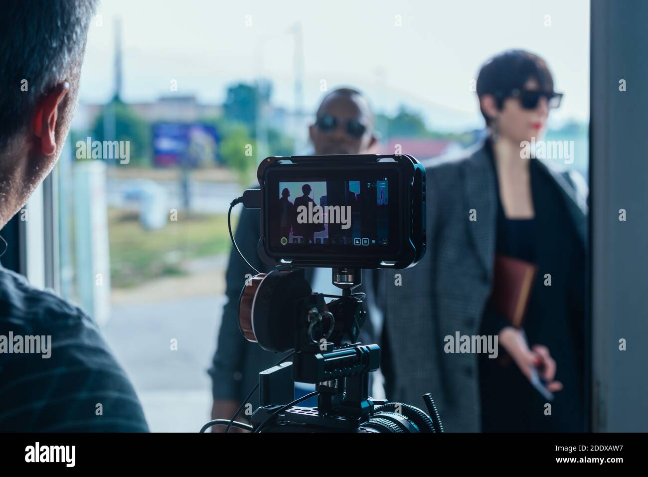 Professional videographer filming interview hi-res stock photography ...