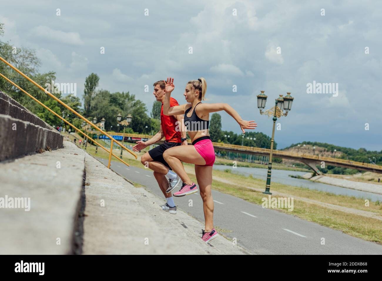 Healthy active couple exercising cardio and sprinting staircase in a ...