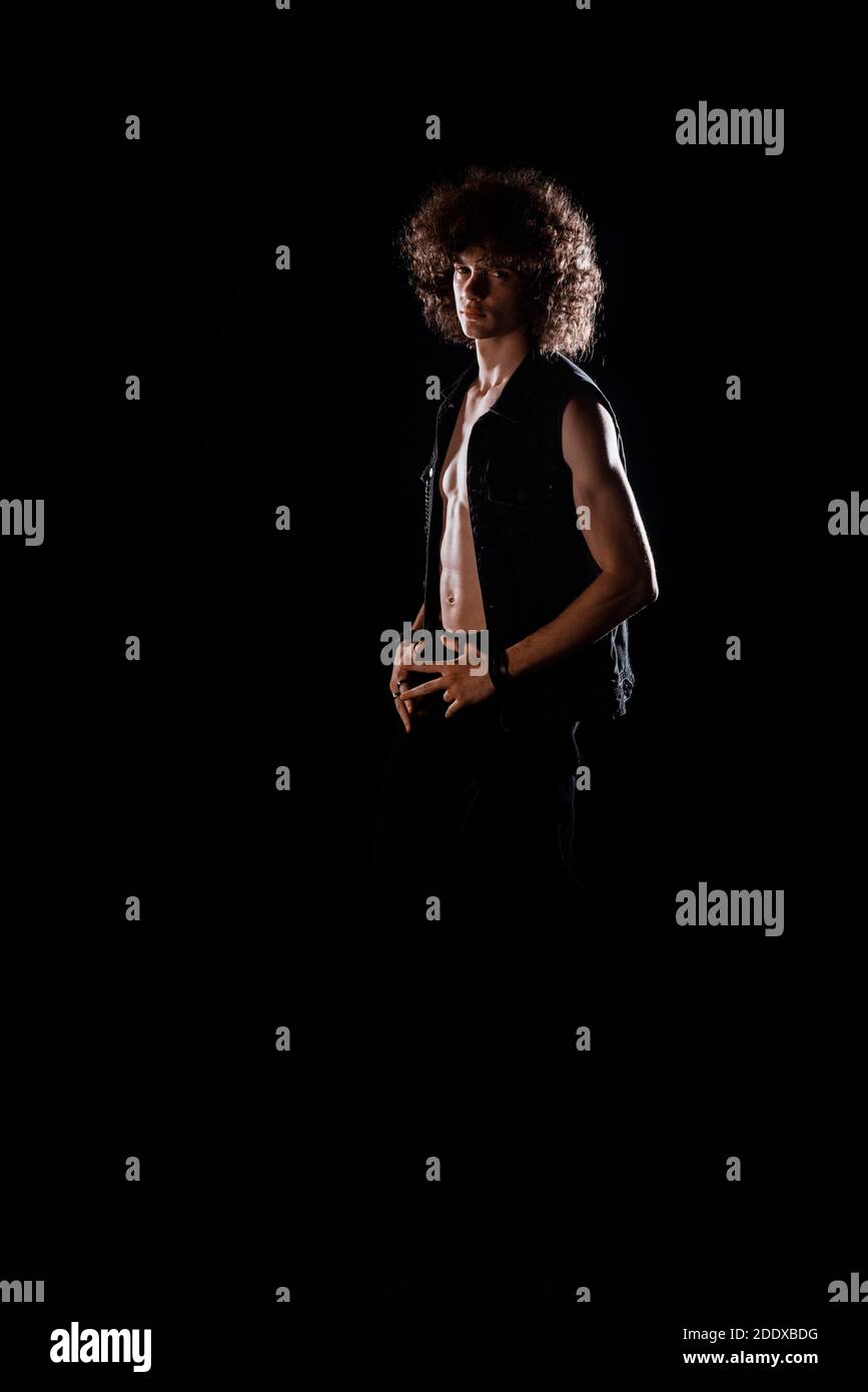 Fashion model posing wearing rock clothing isolated on black wall Stock ...