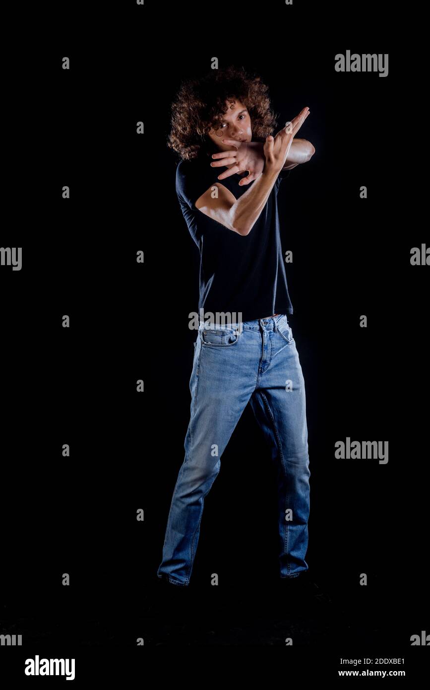 Body shot of an attractive male punk model posing isolated on black ...