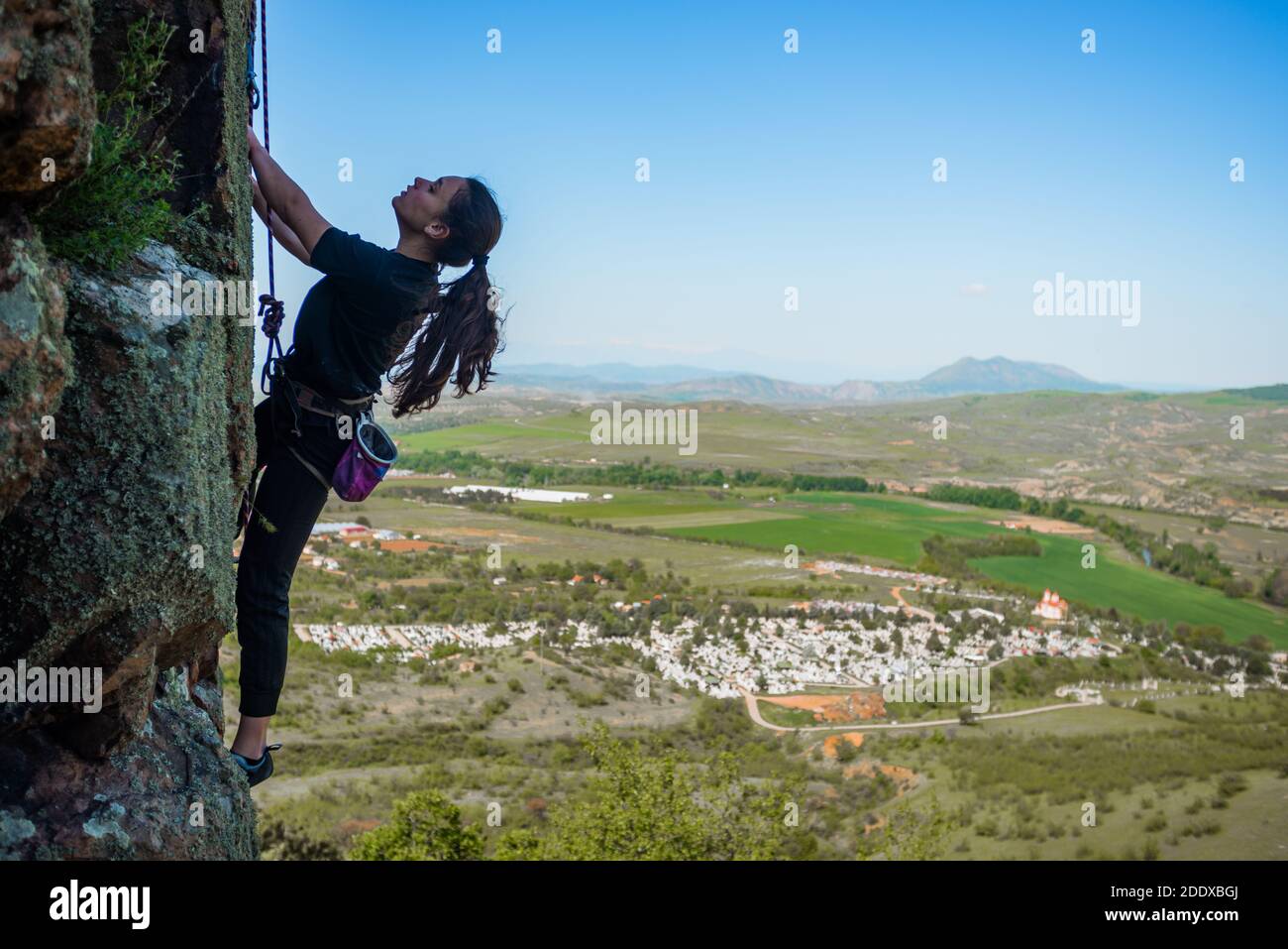 Female extreme climber conquers steep rock against the sunrise Stock ...