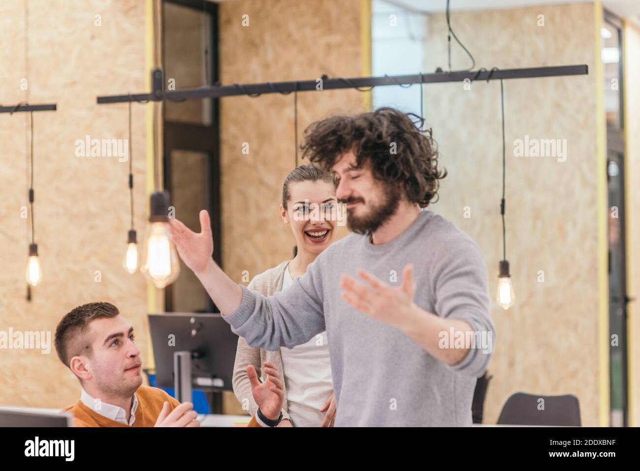 Group of coworkers, colleagues having fun at the office while chatting ...