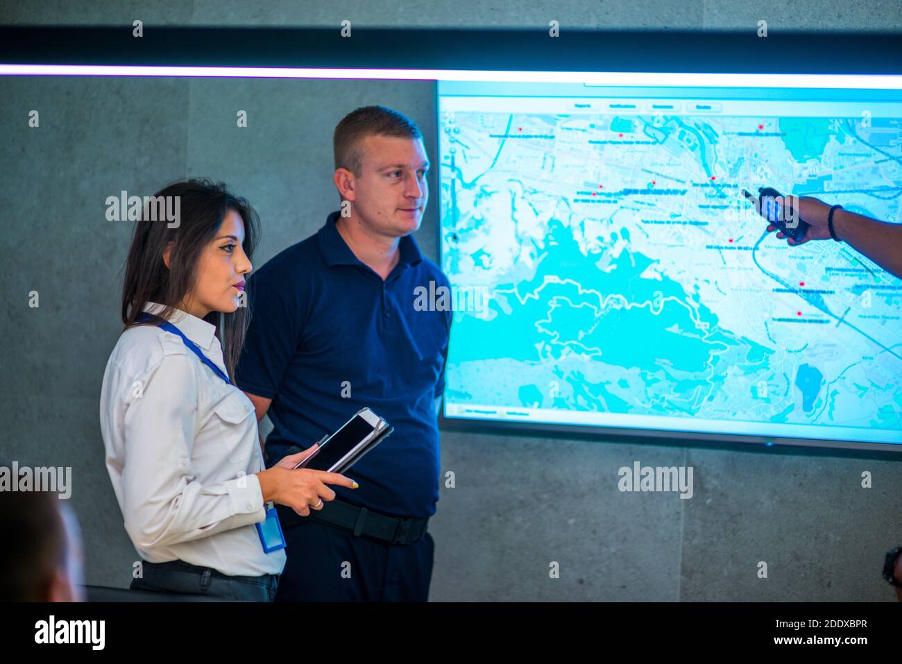 Security guards and policemen holdng portable transmitter having ...